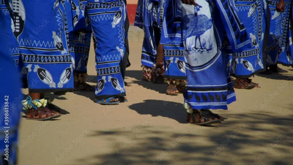 Legs of South African dancers united in rhythm, tribal costumes, slow ...