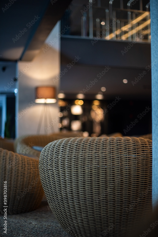 Rattan furniture set in a reception area of a resort lobby. Interior ...