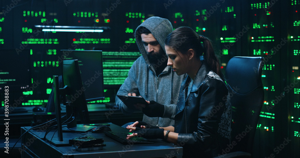 Team of professional hackers using computer for organizing massive data ...