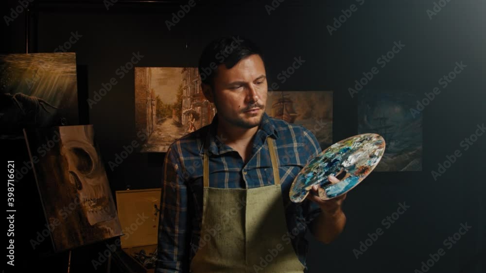 Video Stock Portrait of the talanted artist with palette in his hands ...