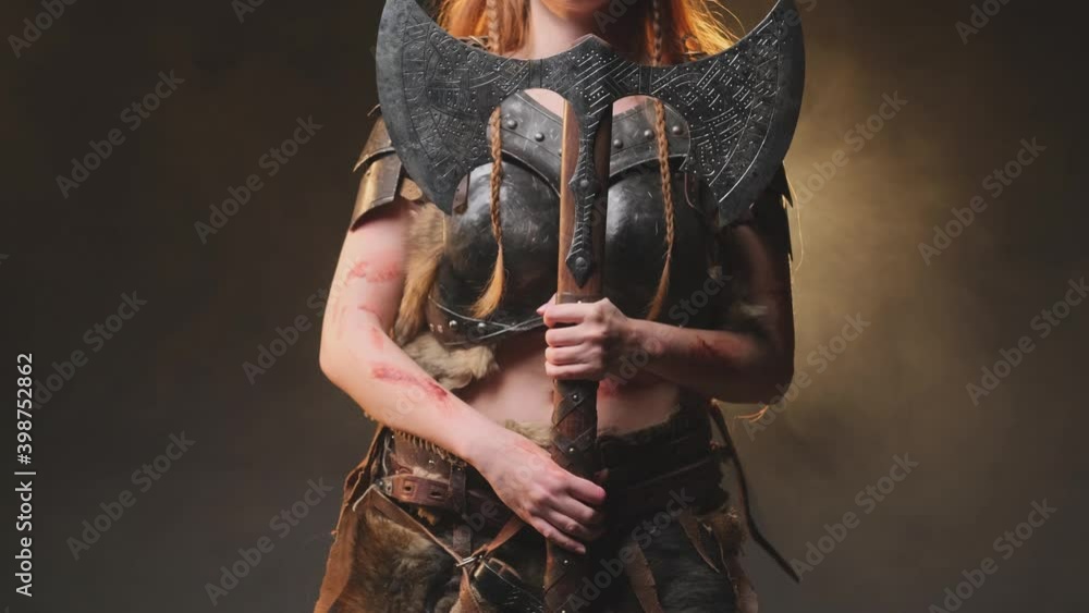 Medieval northern valkyrie with long brown hairs armed with two handed ...