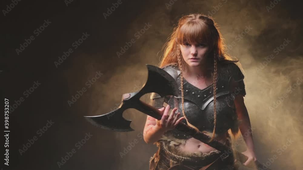 Violent and savage female viking warrior with long brown hairs in steel ...