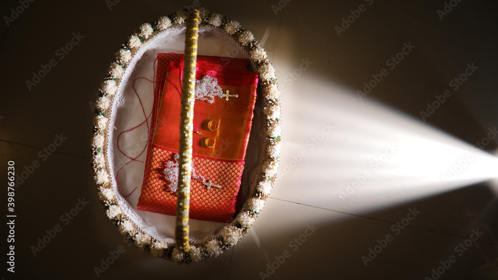 Folded traditional Kerala manthrakodi saree and red silk saree on a ...