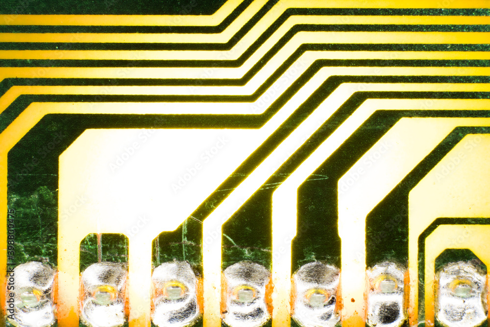 The macro photo of a small part of an electric circuit colored in ...
