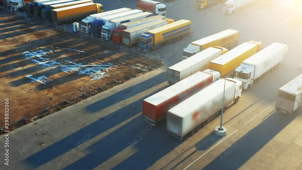 Trucks with semi-trailers arrive to load and unload goods to the large ...