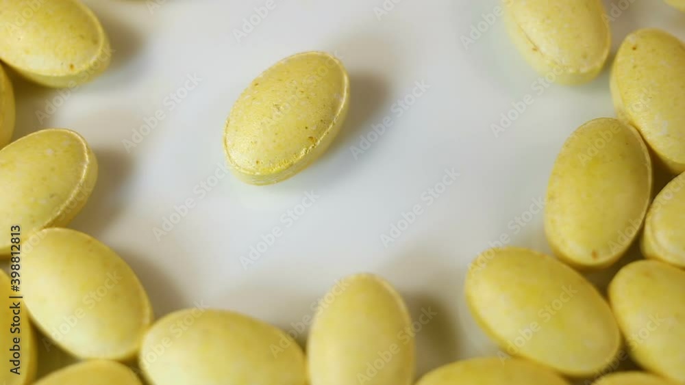 Lemon oval pressed tablets without a shell close-up, one tablet is ...