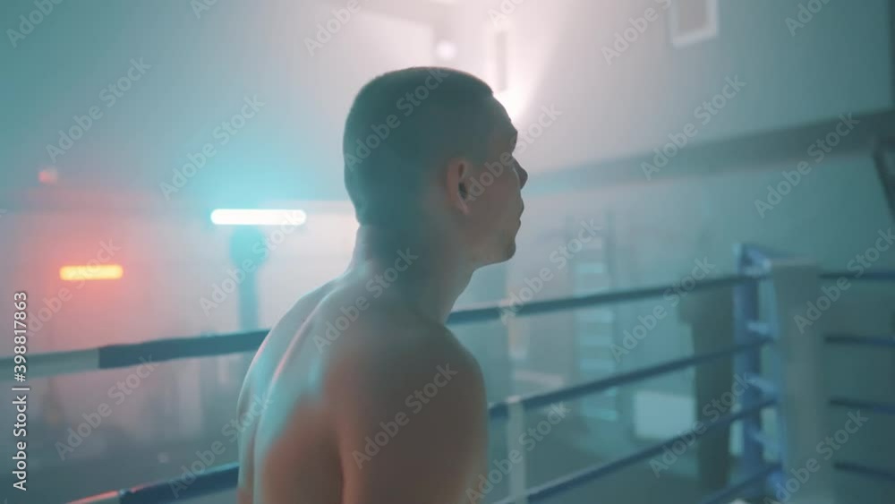 Boxer in the boxing gym. Bandages his hands. Sparring in the ring ...