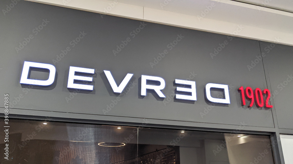 Foto de Devred 1902 logo text and sign front of shop man for clothes ...