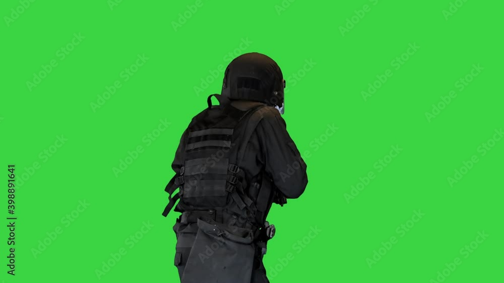 Armed SWAT Police Officer Aiming With a Rifle on a Green Screen, Chroma ...
