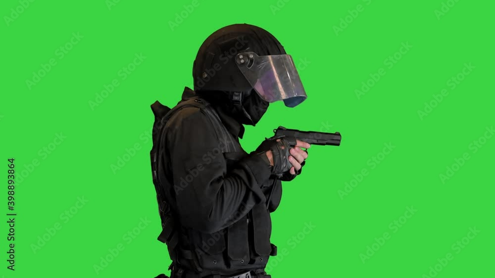 Counter terrorist squad fighter walking and aiming with pistol on a ...