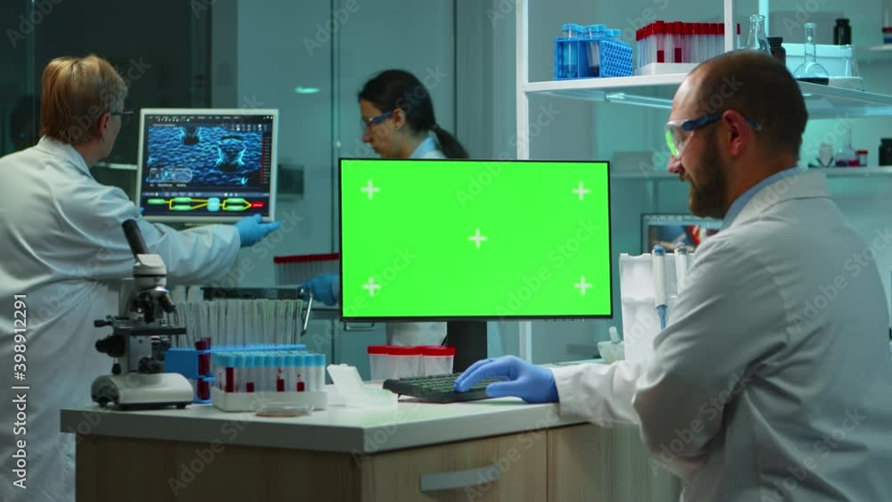 Man researcher looking at chroma key computer in modern equipped lab ...