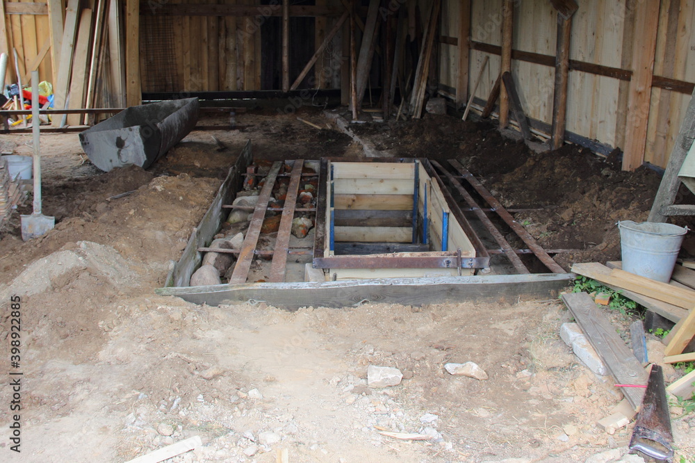 Construction of an observation pit for a car in a village garage ...