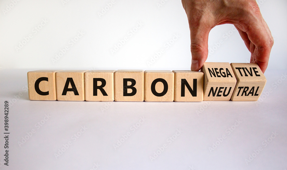 From carbon neutral to negative. Hand flips cubes and changes words ...