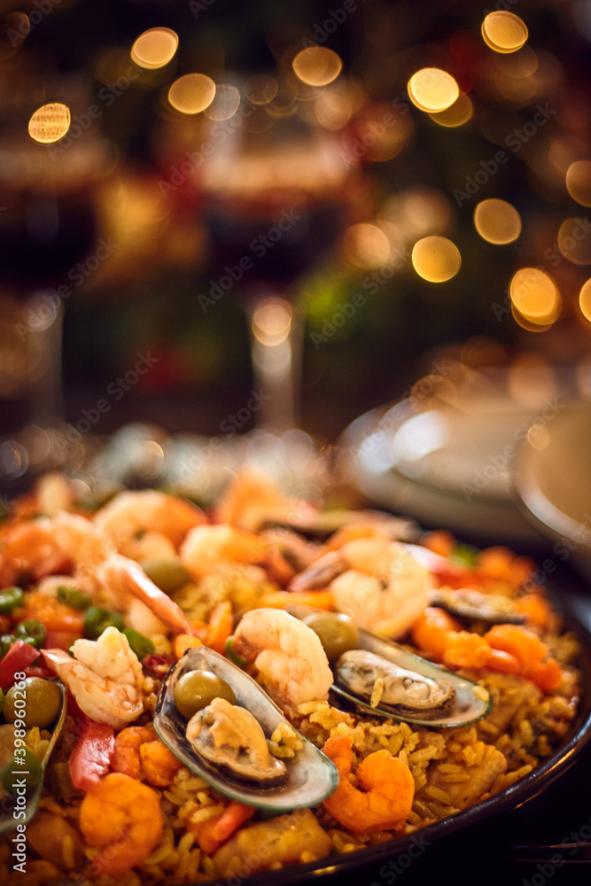 Spanish dinner table with assortment of dishes. paella, octopus, whole ...