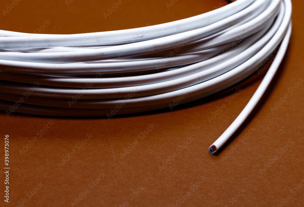 Coiled electric wire for lighting installation. close. blurry focus ...