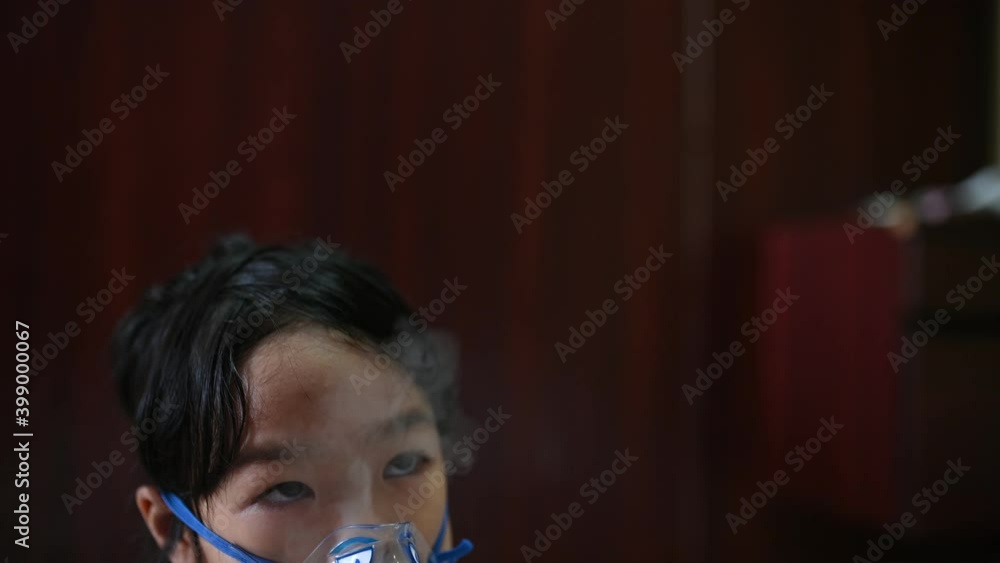 Asian Sick girl inhalation therapy by the mask of inhaler,A little girl ...