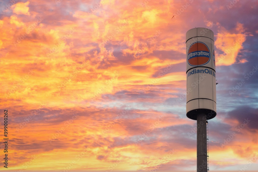 Signage of indian oil petrol pump shot against a monsoon clouds and ... Signage of indian oil petrol pump shot against a monsoon clouds and ...