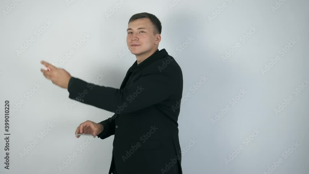 Illusionist is tryng to do trick. Magician man in black suit is making ...