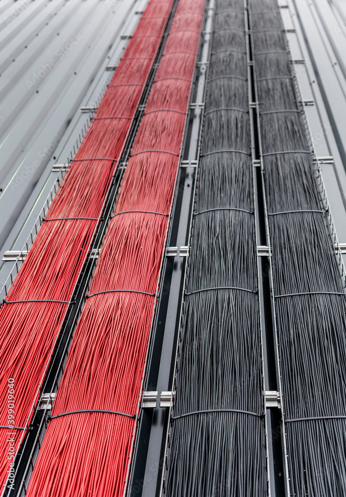 Cable tray with red and black solar cables in it for solar power plant ...