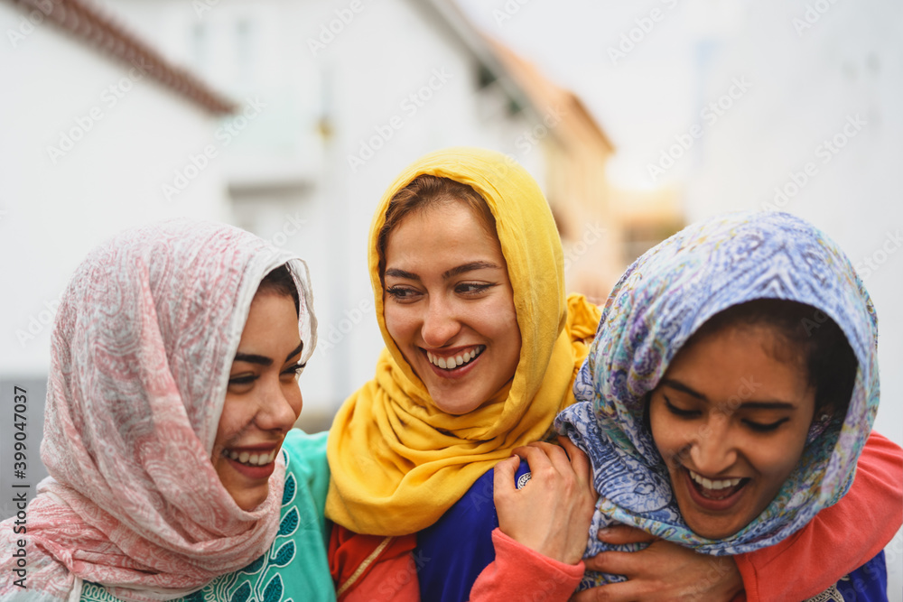 Happy Muslim women walking in the city center - Arabian young girls ...