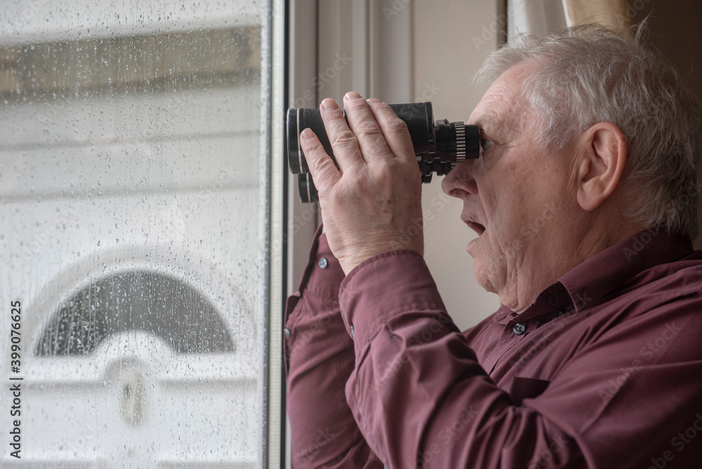 Nosy neighbor looking through window with binoculars with shocked ...