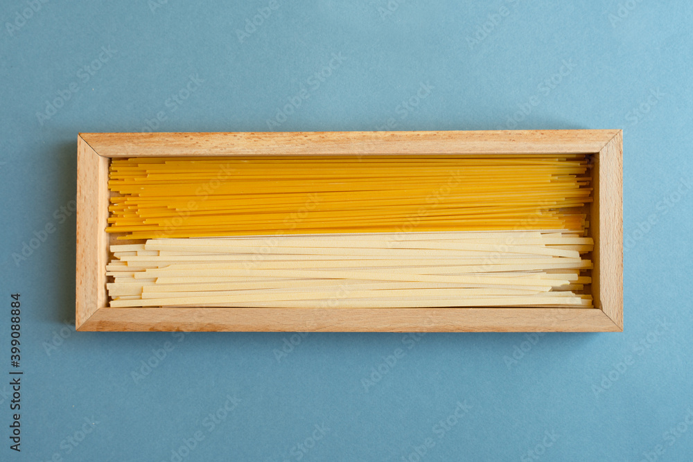 spaghetti and tagliatelle line on light blue background. pasta in a ...