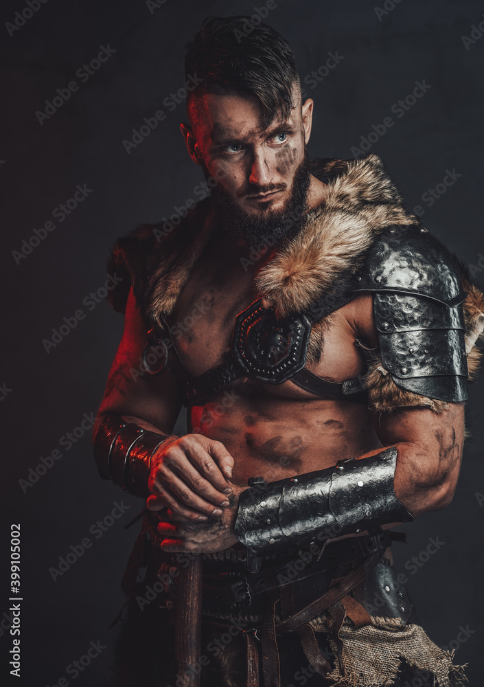 Barbaric and grimy northern vandal in light armour with fur posing in ...