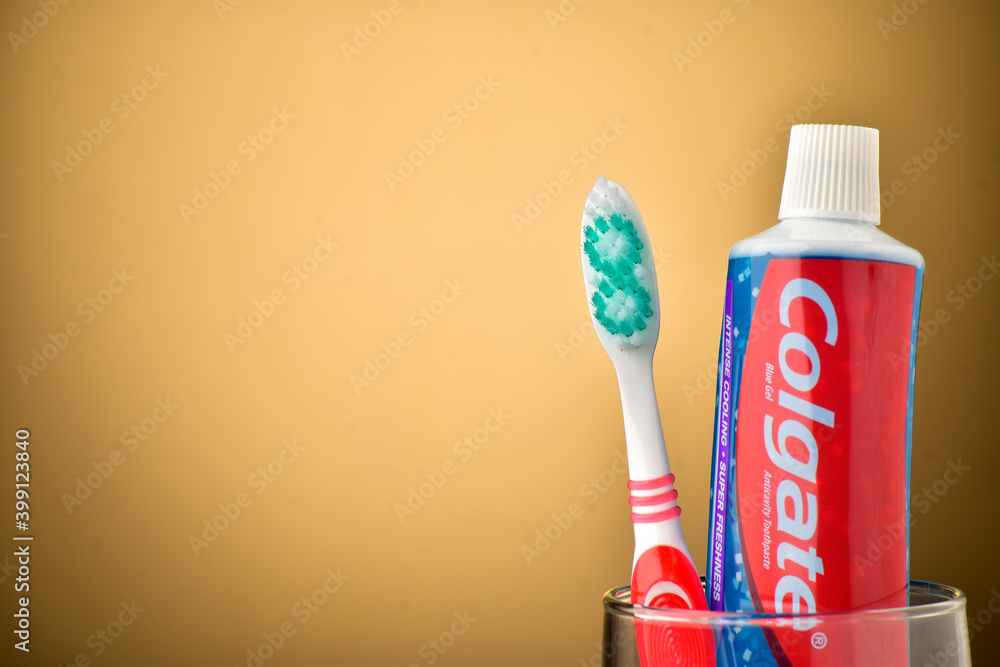 colgate toothpaste with tooth brush on brown background with copyspace ...