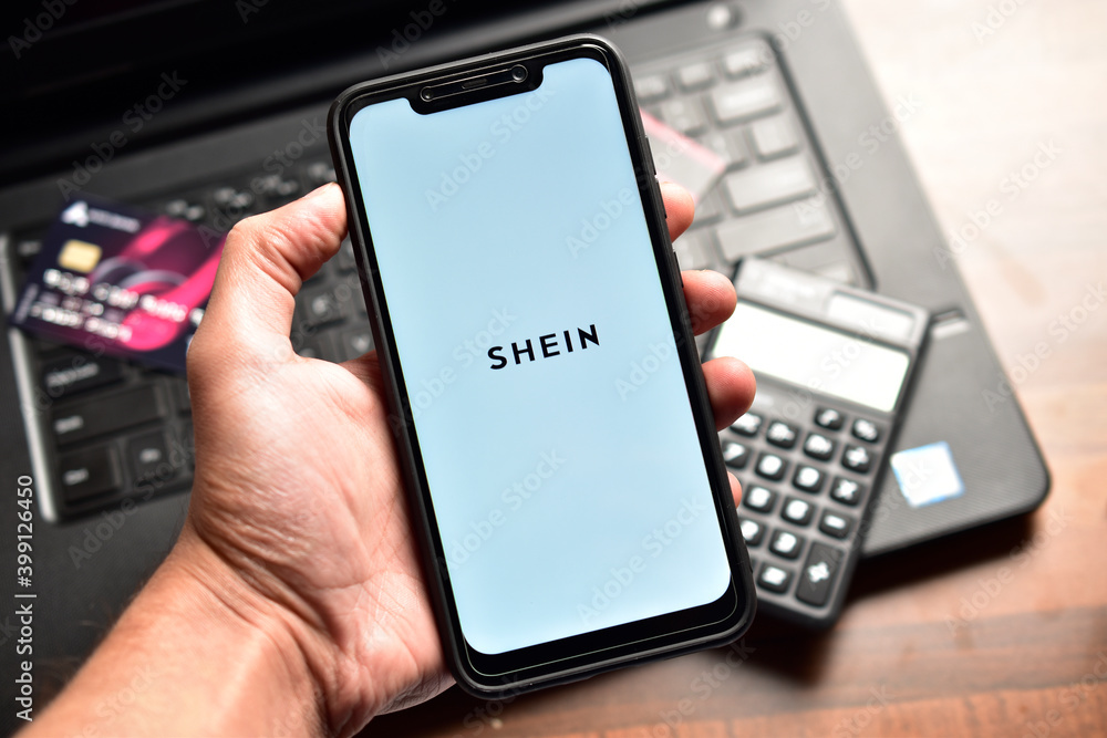 shein fashion ecommerce website, hand holding smartphone using shein ...