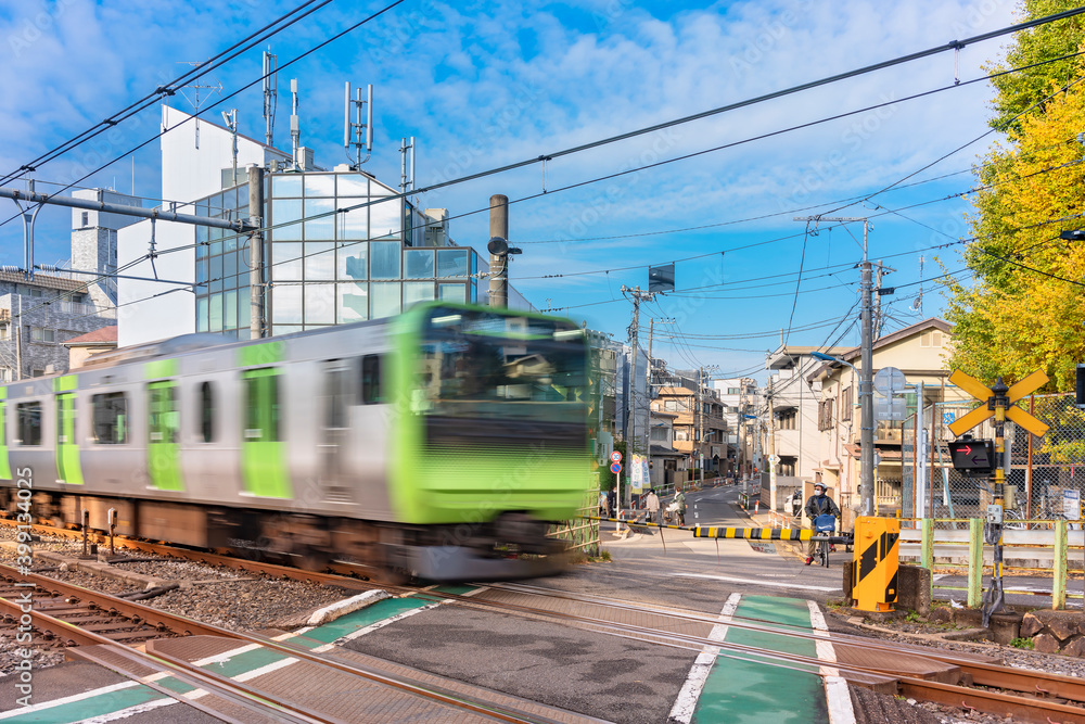 Japan Railway train at fast speed passing over the level crossing of ...