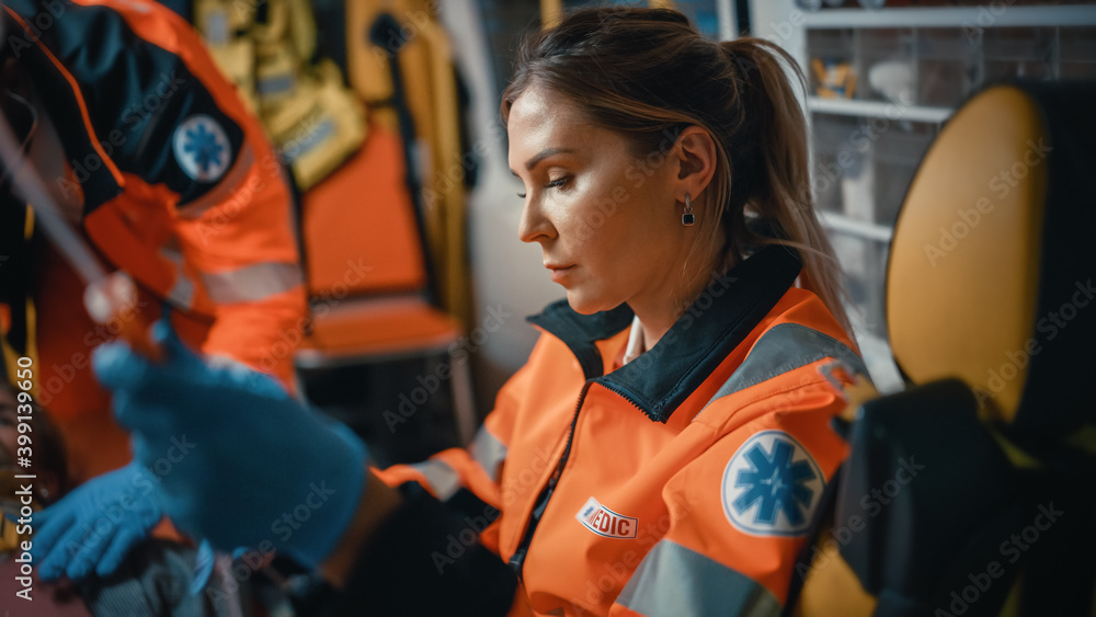 Female and Male EMS Paramedics Provide Medical Help to an Injured ...