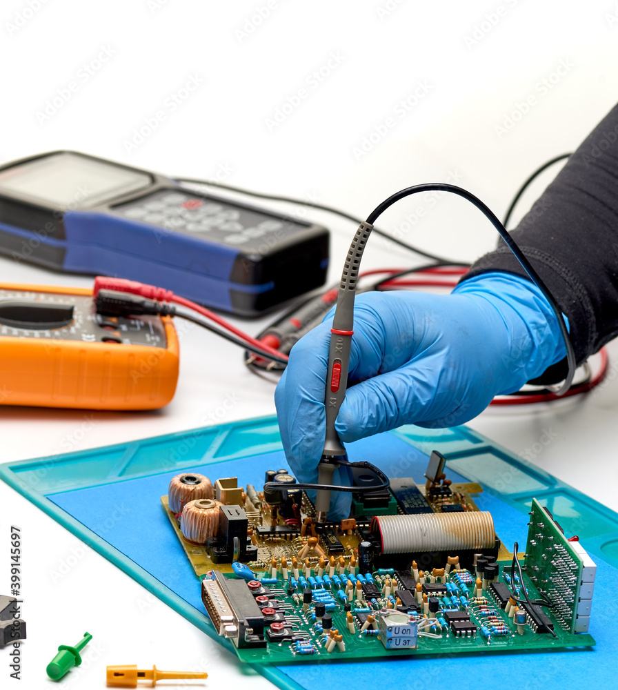 Electronics repair service-the master checks the electronic unit and ...