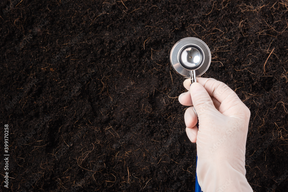 Hand of researcher woman wear gloves holding a stethoscope on fertile ...