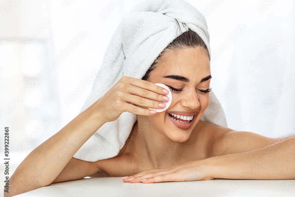 Woman removing makeup with cotton swab pad. Young girl taking care of ...