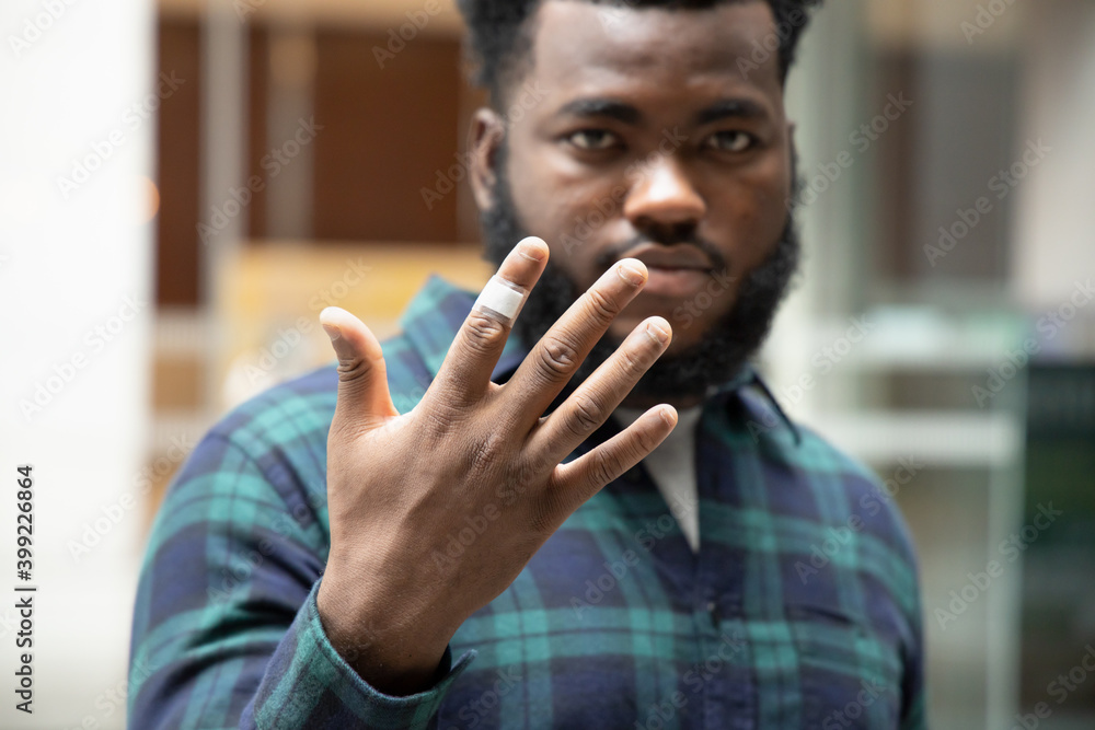 African man having cut wound on his hand, wound dressed by plastic ...