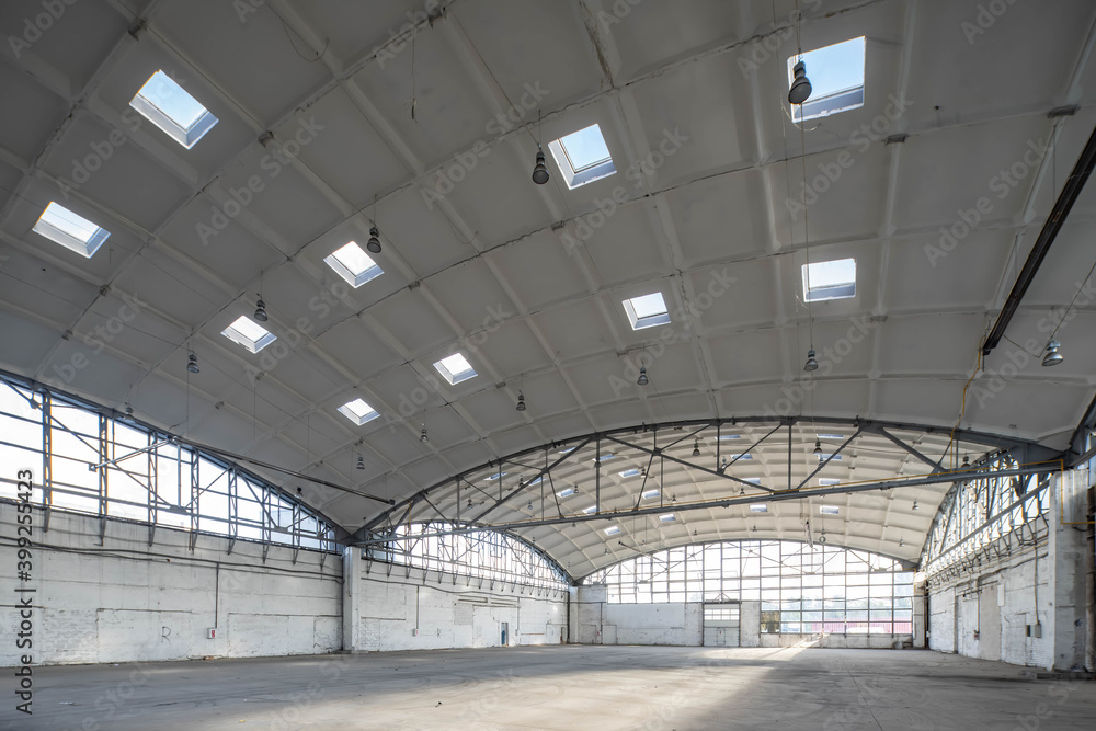 Huge empty industrial warehouse. White interior. Unique architecture ...