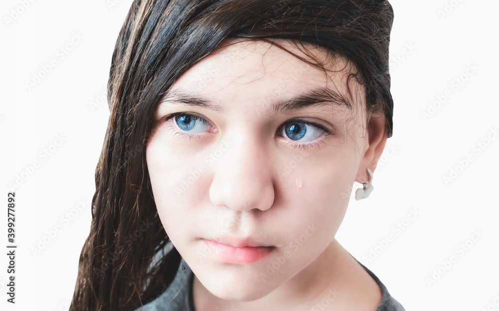 Sad girl with wet hair and tear on her cheek. Stock Photo | Adobe Stock
