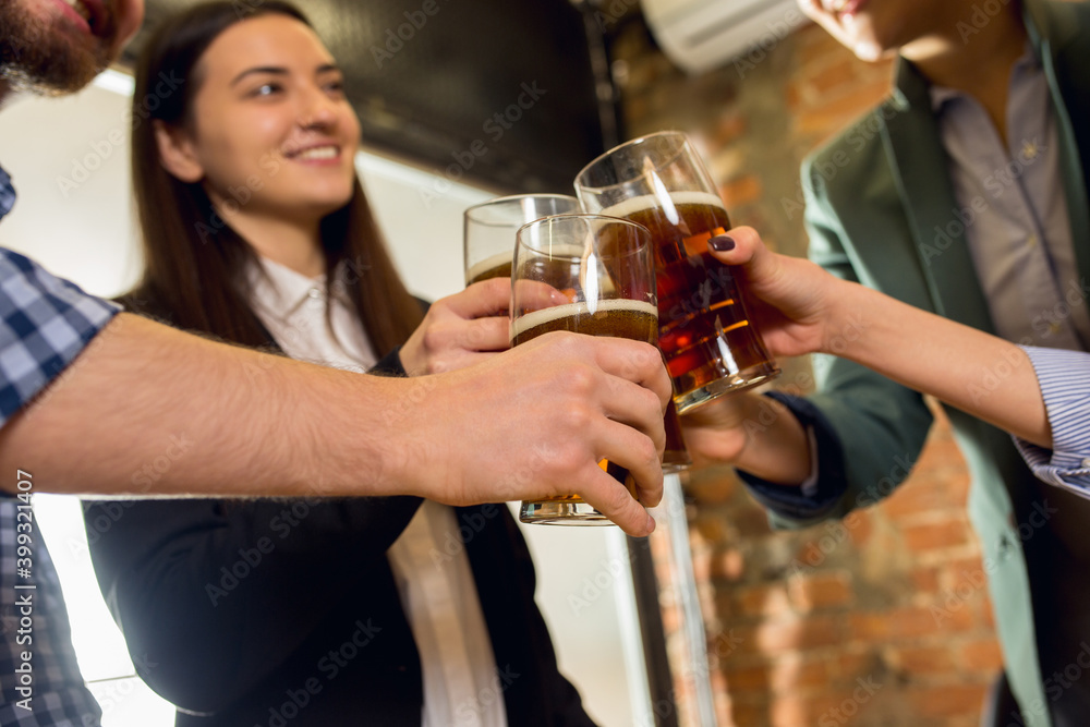 Clinking. Happy co-workers celebrating corporate event after tensioned ...