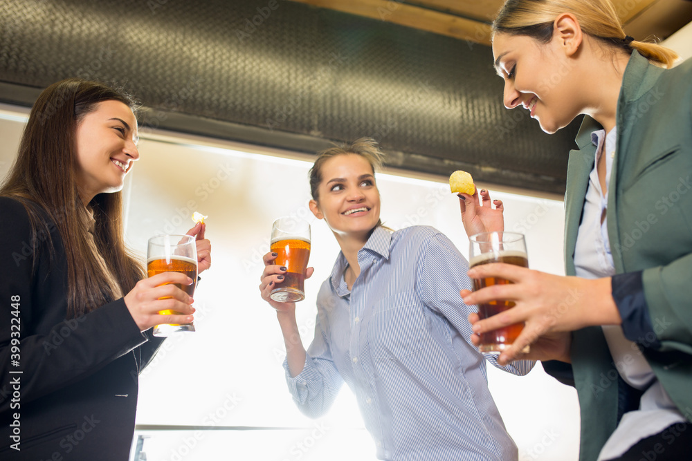 Snack. Happy co-workers celebrating corporate event after tensioned ...