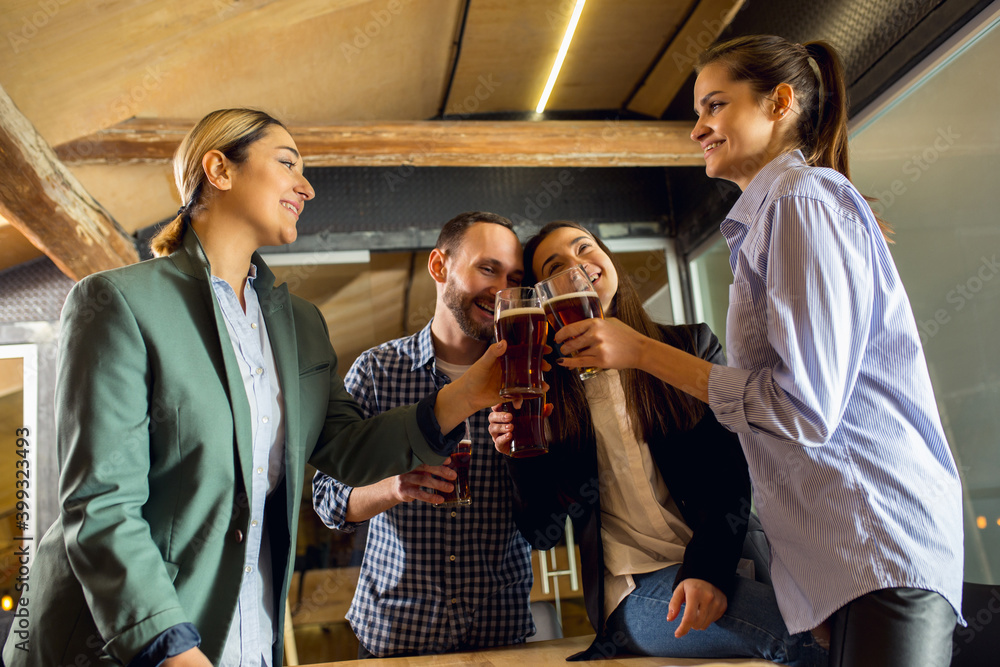 Clinking. Happy co-workers celebrating corporate event after tensioned ...