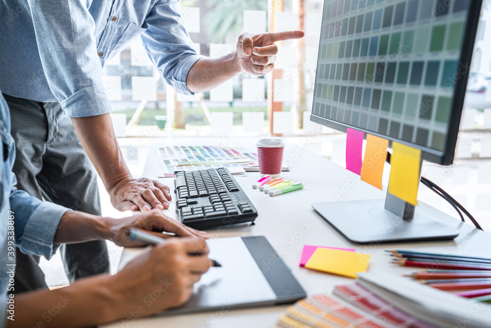 Young colleagues designers working together on a creative project and ...