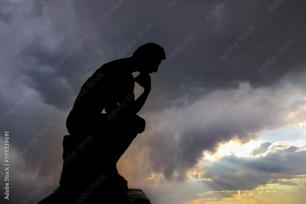 Sculpture thinking man in sunset silhouette. Concept photo. Stock Photo ...