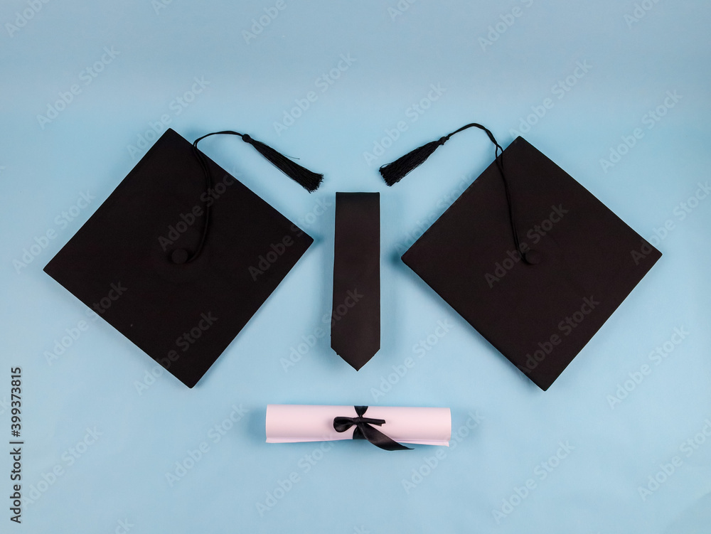Two graduation caps, a tie and a certificate on a blue background ...