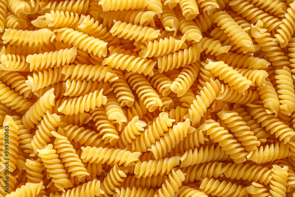 Dry pasta fusilli. Fusilli have spiral shape and yellow color. Pasta is ...