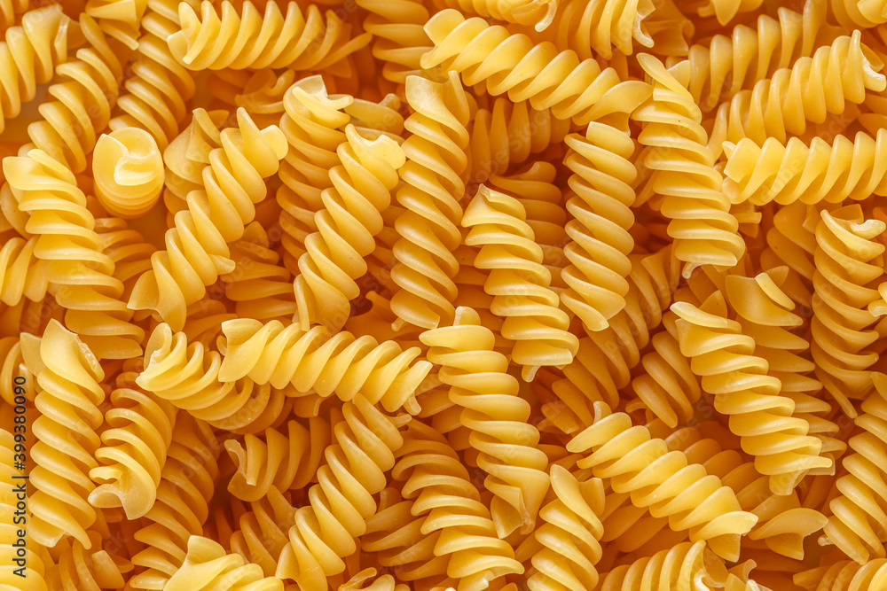 Dry pasta fusilli. Fusilli have spiral shape and yellow color. Pasta is ...