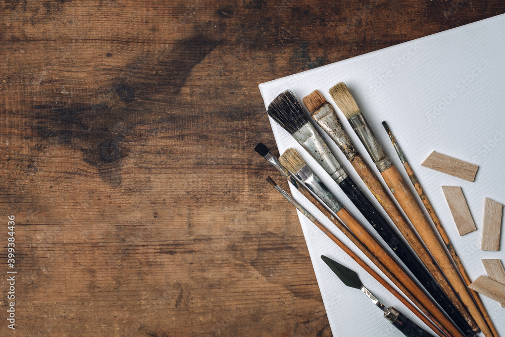 Artistic tools on old dark wooden table. Set brushes for oil painting ...