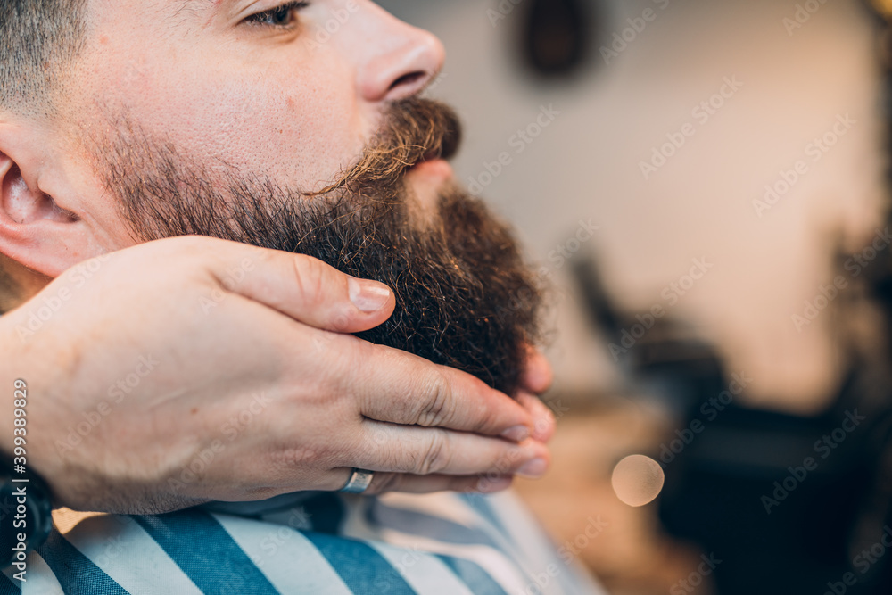 Young good looking hipste man visiting barber shop. Trendy and stylish ...