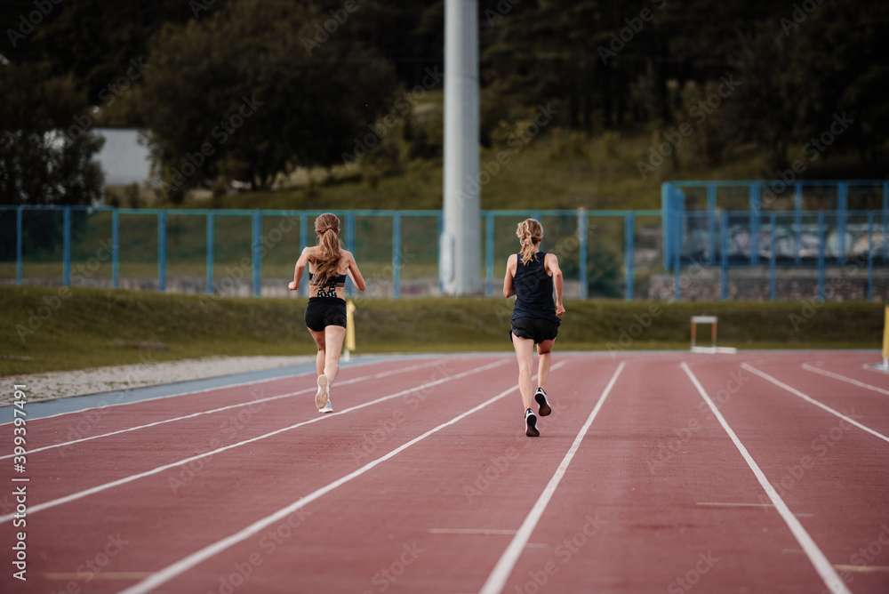 Track and field athletes training at stadium Stock Photo | Adobe Stock