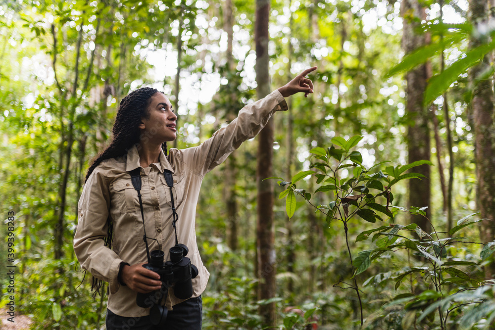 Girl in the Amazon jungle pointing upwards Stock Photo | Adobe Stock