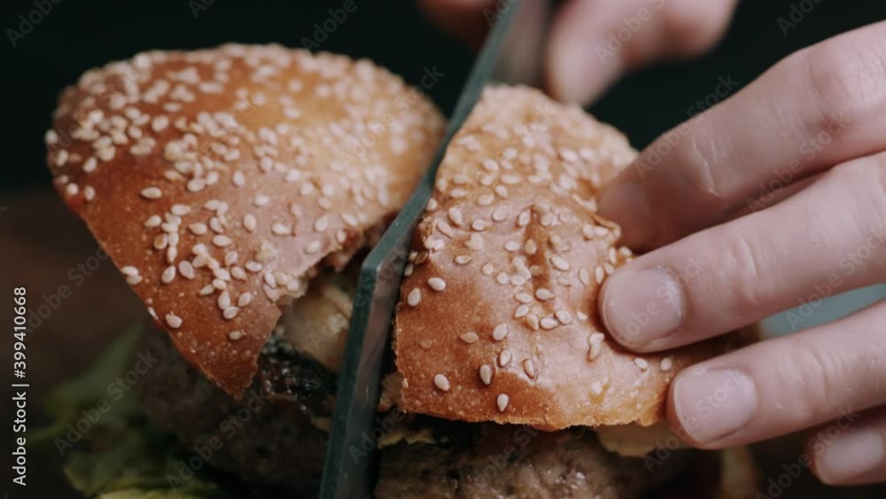 Beef Burger Being Cut On The Half With A Sharp Knife Stock ビデオ | Adobe ...